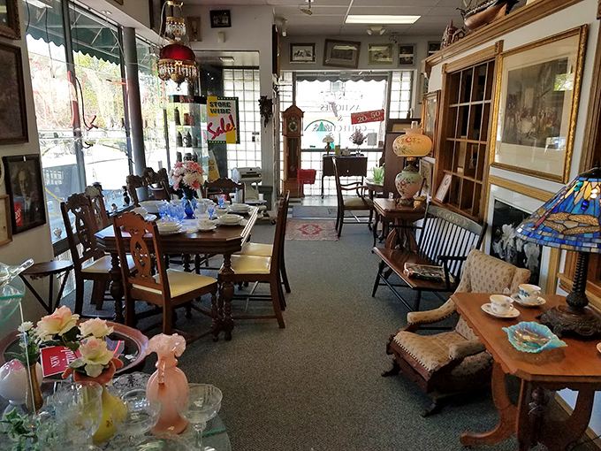 Furniture that has already lived several lives sits ready for its next chapter. That chair has heard more family secrets than any therapist.
