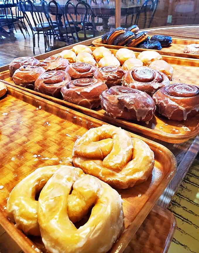 A wooden tray showcases the morning's bounty &ndash; golden rings of joy waiting to transform ordinary coffee breaks into moments of pure bliss.