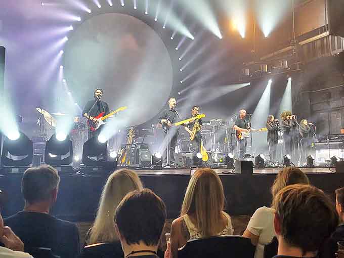 Modern lighting technology meets historic grandeur as contemporary performers bring fresh energy to a stage that's hosted entertainment legends.