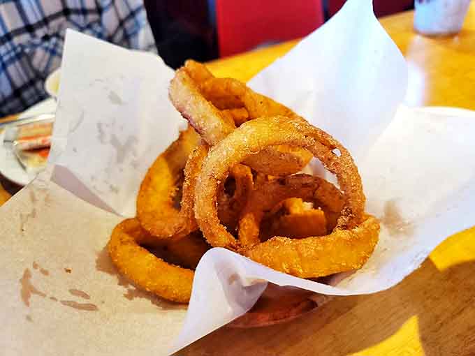 These onion rings deserve their own fan club &ndash; crispy, substantial, and requiring a two-handed approach to proper enjoyment.