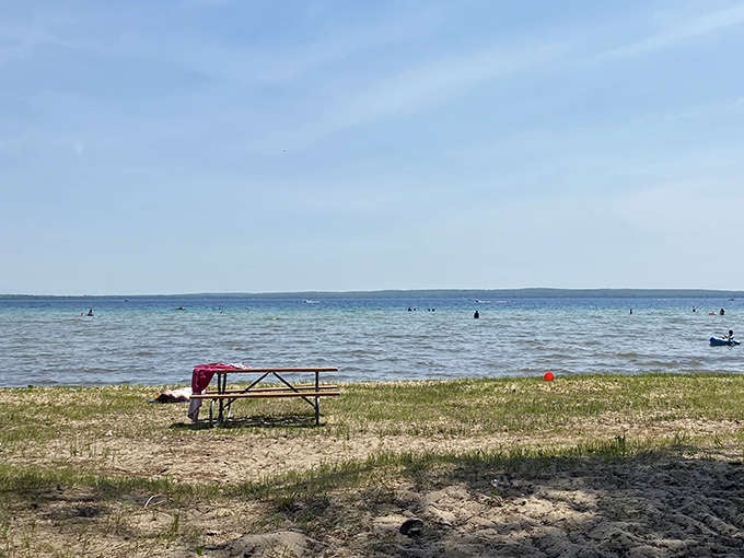 A lone picnic table waits patiently for families to create memories over sandwiches with that unmistakable hint of sunscreen and joy.
