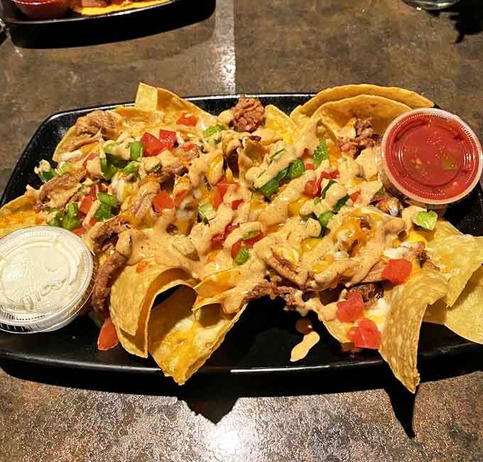 BBQ nachos that make regular nachos question their life choices &ndash; topped with pulled pork, cheese, and enough toppings to require a fork.