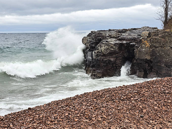 Drama queen alert! Lake Superior shows off its powerful side, sending waves crashing against ancient volcanic rock formations.