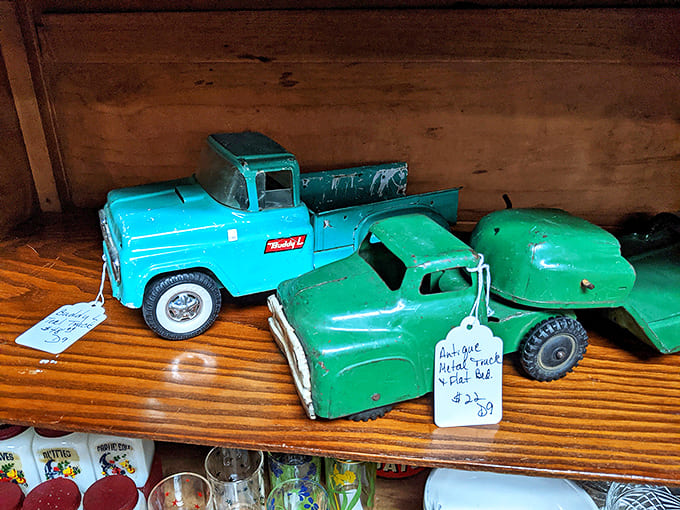 Vintage pressed-steel toy trucks sit ready to roll, their weathered paint telling stories of childhood adventures from generations past and future.