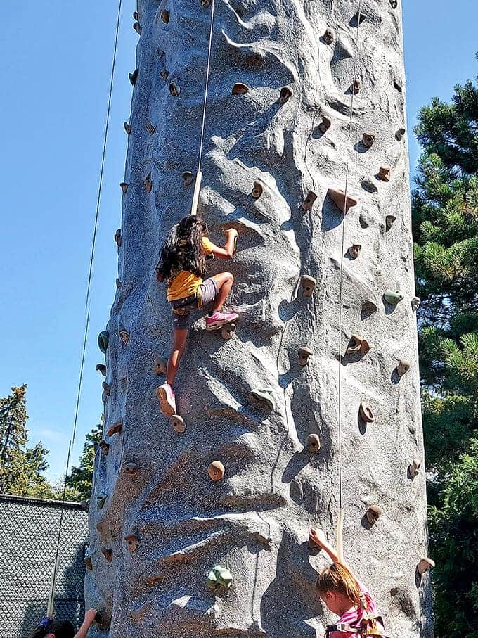 Young adventurers scale new heights on this climbing wall, each handhold a step toward conquering their own personal Everest.