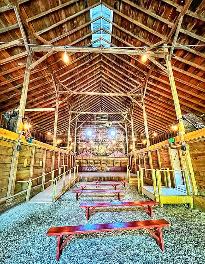 Sunlight streams through the rustic barn's wooden beams, illuminating a space where community gatherings once brought the frontier to life.