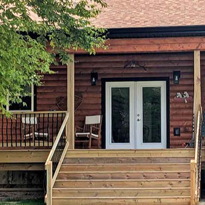 Morning light bathes this rustic retreat's wooden deck &ndash; the kind of place where coffee tastes better and problems seem smaller.