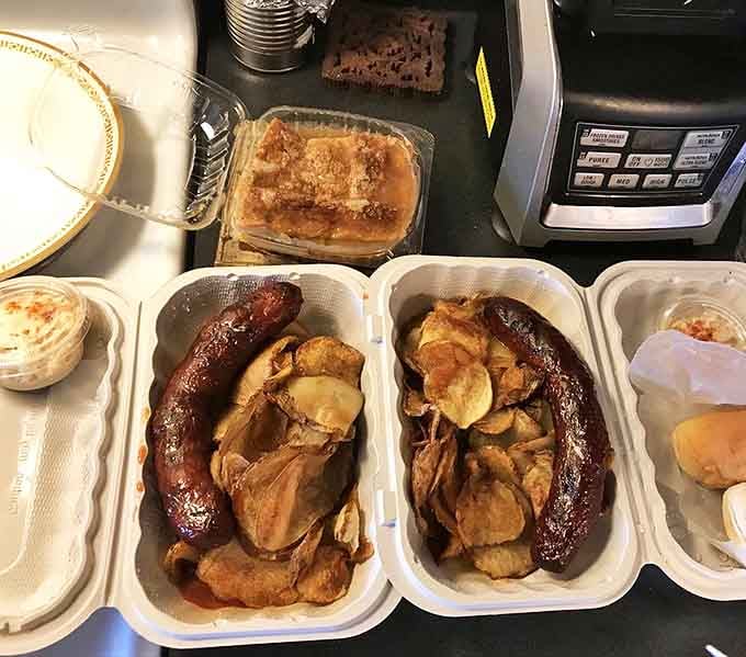 Sausages lounging among homemade potato chips &ndash; a lunch combo that makes fast food chains weep with inadequacy. Simple perfection on a plate.