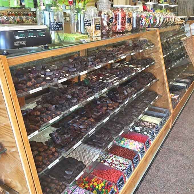 The display case offers a museum-worthy collection of chocolates and confections, each piece handcrafted with the kind of attention that mass production can never replicate.