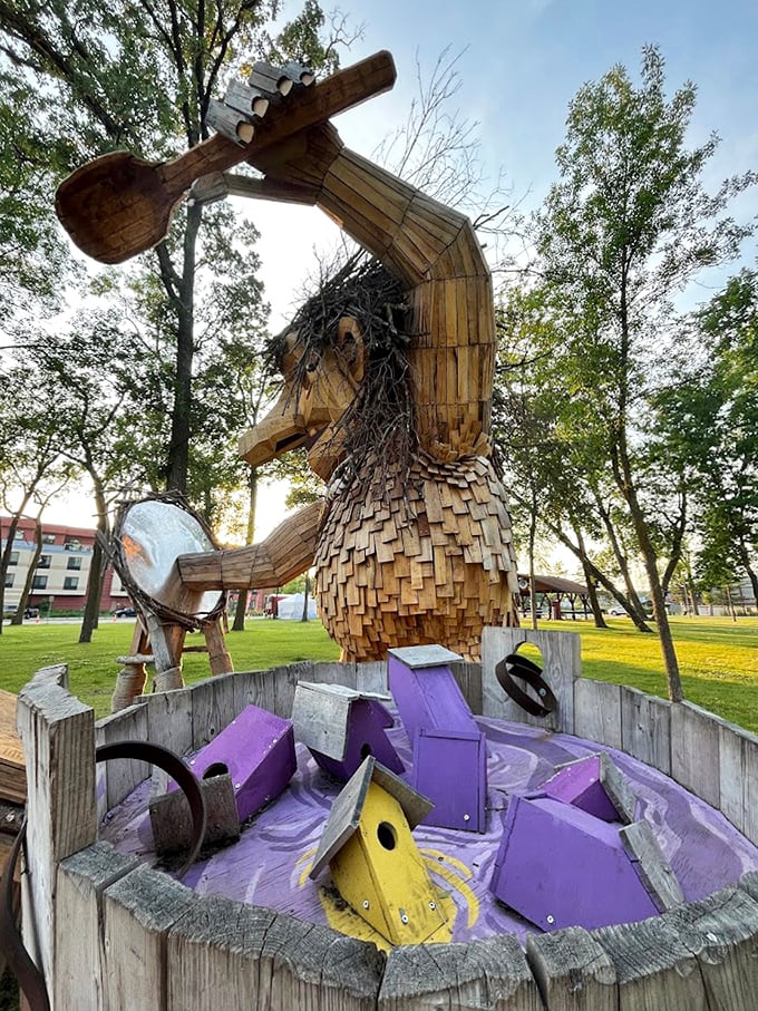 "I've got a soup of birdhouses and I'm not afraid to use it!" This wooden guardian seems to be collecting homes for his feathered friends with enthusiastic abandon.