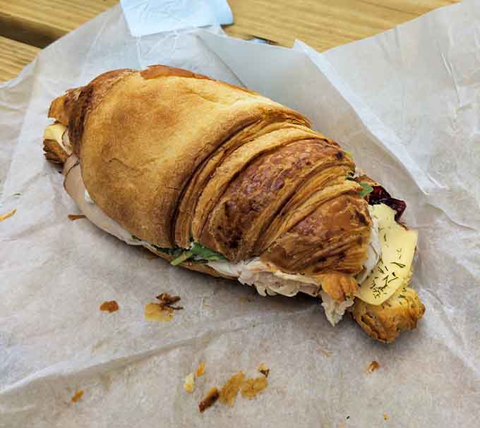 This isn't just a sandwich &ndash; it's architecture of flavor, with layers of goodness nestled between flaky, buttery croissant perfection.