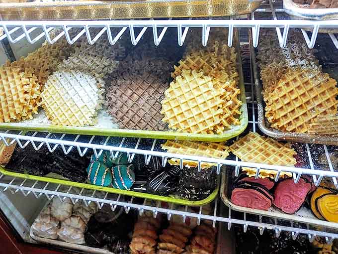 Waffle cookies in various stages of deliciousness&mdash;some dusted with powdered sugar, others dipped in chocolate&mdash;perfect companions for your afternoon coffee.