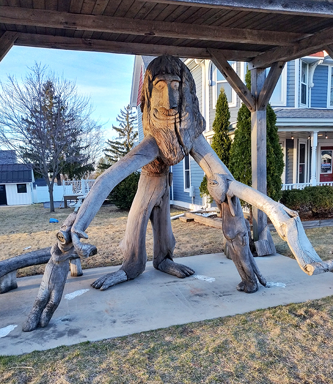 This wooden giant looks like he's mid-stride through town, arms outstretched as if to say, "Come on in, the trolling's fine!"