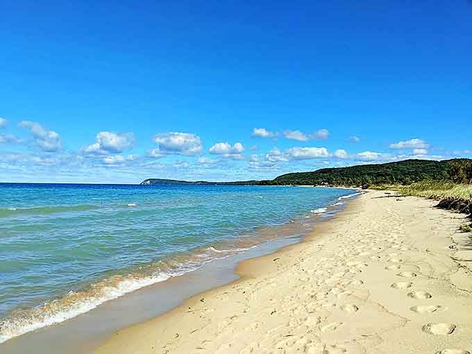 Good Harbor Bay stretches toward the horizon, its shallow waters creating bands of blue that shift from turquoise to navy.
