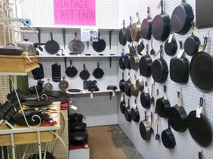 Cast iron paradise! Bonanza Antiques features an impressive wall of vintage cookware that would make any kitchen enthusiast's heart skip a beat.
