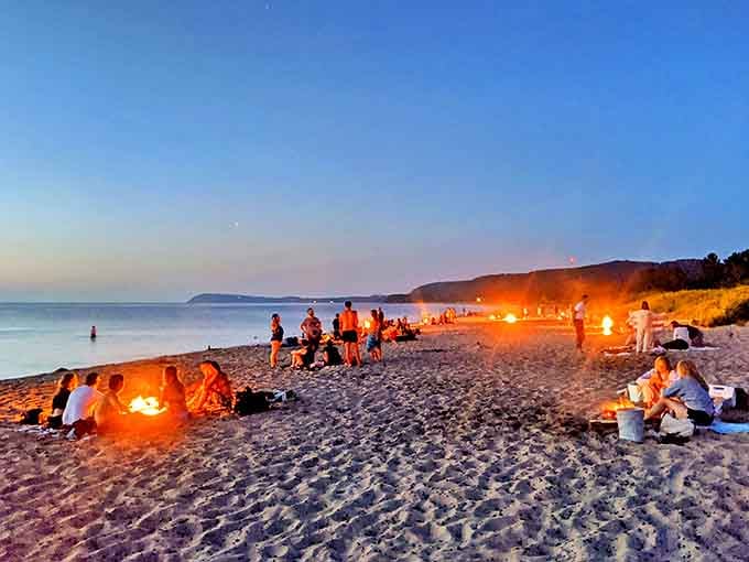 Nightfall at Good Harbor Bay transforms the beach into a gathering place, where stories are shared around flickering flames.