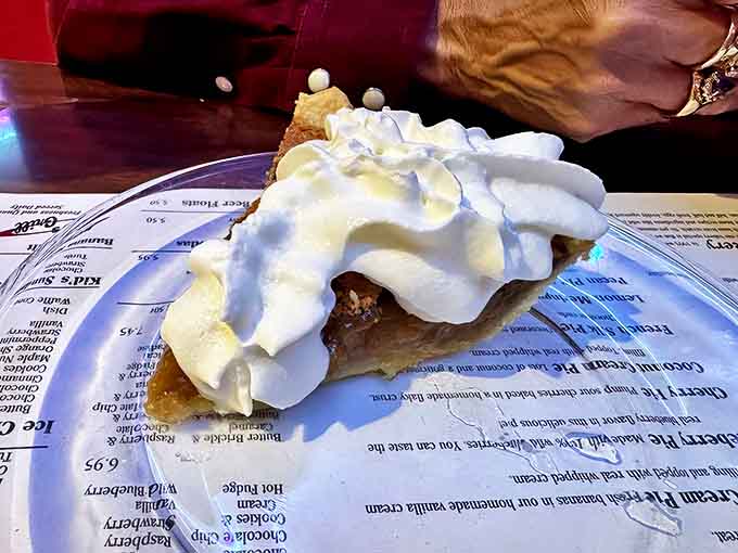 Pecan pie crowned with a cloud of whipped cream &ndash; proof that sometimes the best things in life come in triangular form.