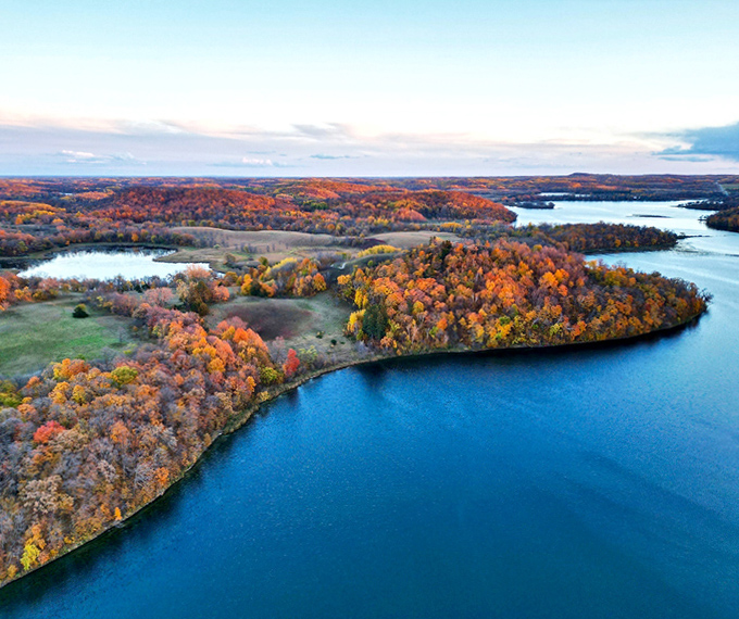 Autumn transforms Otter Tail County into nature's color palette, where fiery trees and sapphire waters create a masterpiece no artist could replicate.