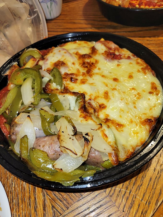 A sizzling Italian sausage masterpiece with peppers and onions &ndash; proof that happiness can indeed be served in a cast iron skillet.