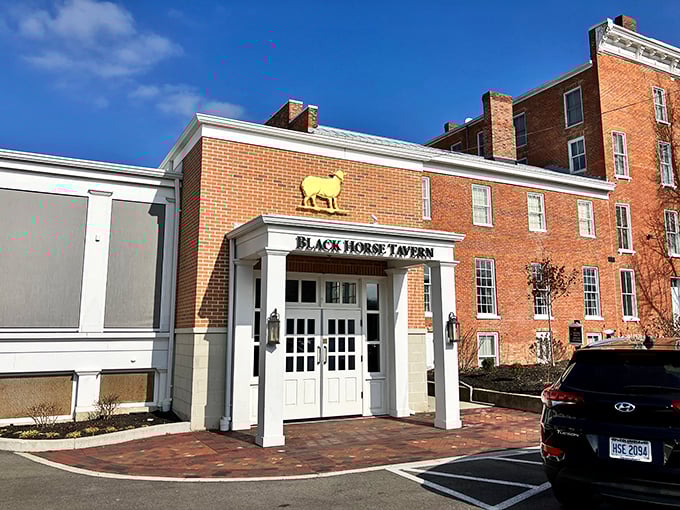 Black Horse Tavern's iconic golden sign promises comfort food and local brews in an atmosphere that's sophisticated yet utterly unpretentious.