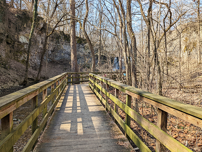 This wooden pathway isn't just a trail – it's a bridge between worlds, leading from concrete jungle to natural sanctuary.