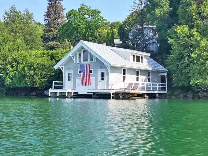 Charming boathouses dot the shoreline like something from a storybook, adding character to an already picturesque scene.