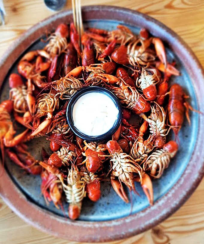 These ruby-red crayfish, piled high and ready for peeling, transform dinner into a deliciously messy communal experience.