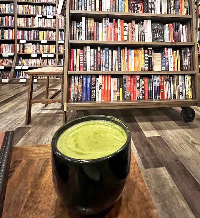 This vibrant green cup of zen provides the perfect contemplative companion while browsing shelves of philosophy and mindfulness books nearby.