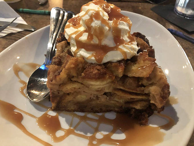 Bread pudding that would make grandma both proud and jealous. Topped with whipped cream and caramel, it's dessert architecture at its finest.