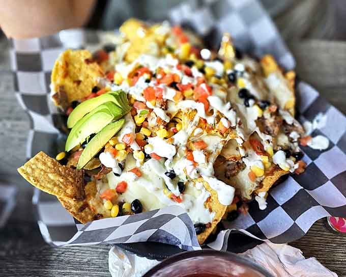 These loaded nachos don't just talk the talk &ndash; they walk the walk with fresh avocado, black beans, and enough cheese to make Wisconsin nervous.