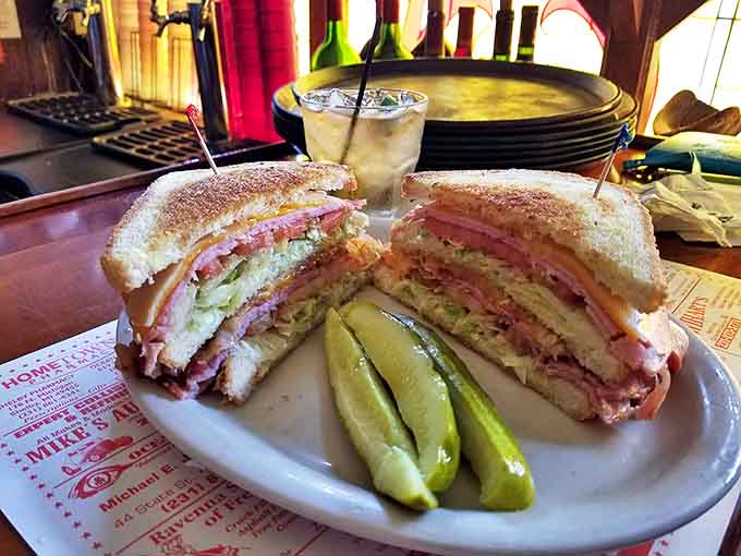 This club sandwich stands tall and proud, layers of meat and veggies between toasted bread with pickle spears standing guard. A lunch that means business!