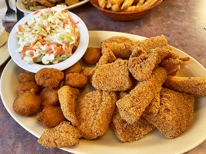 Cornmeal-crusted catfish bites with creamy coleslaw &ndash; proof that Chuck's excels beyond the smoker, delivering Southern comfort on a plate.