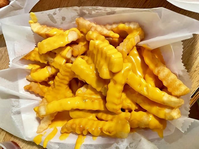 Cheese fries that make you weak in the knees &ndash; golden crinkle cuts smothered in that perfect molten yellow cheese sauce. 