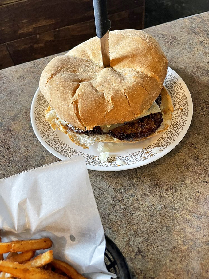 Someone's about to experience pure burger bliss. Notice the proper two-handed approach&mdash;amateur one-handers need not apply.