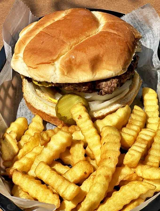 The cheeseburger and crinkle-cut fries combo – a timeless American duet that Laura's elevates from simple meal to transcendent experience.