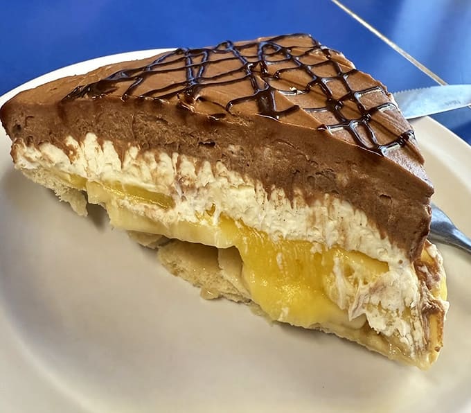 The famous Chocolate Banana Cream Pie layers fresh bananas with vanilla custard and chocolate mousse &ndash; it's basically three desserts having a party on your plate.