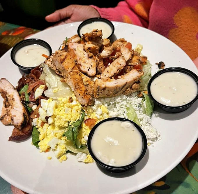 The Cobb salad arrives like a colorful terrain map, with each ingredient forming its own tasty topographical region waiting to be explored.