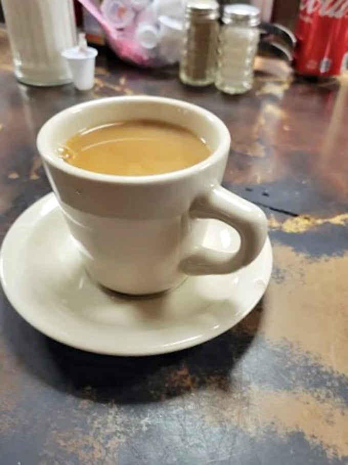 That perfect diner coffee &ndash; not pretentious, just reliable &ndash; served in a thick white mug that somehow makes every sip more satisfying.