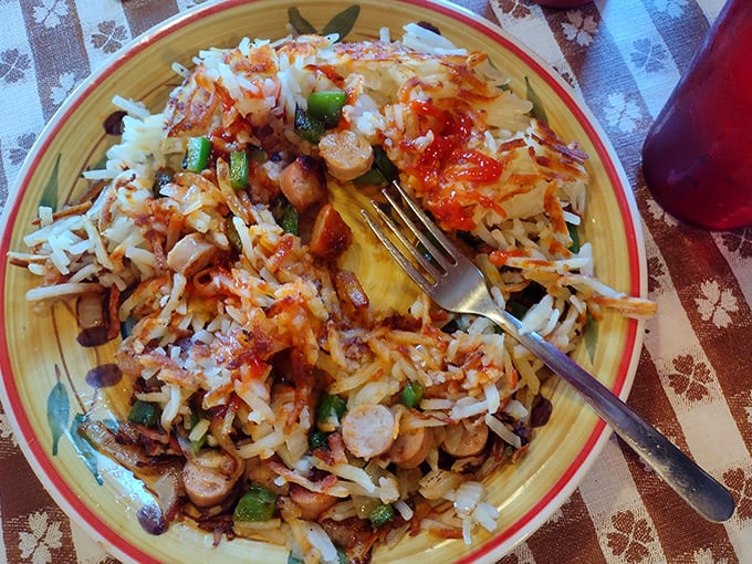 A beautiful chaos of potatoes, sausage, peppers and cheese that makes you wonder why people eat anything else for breakfast.
