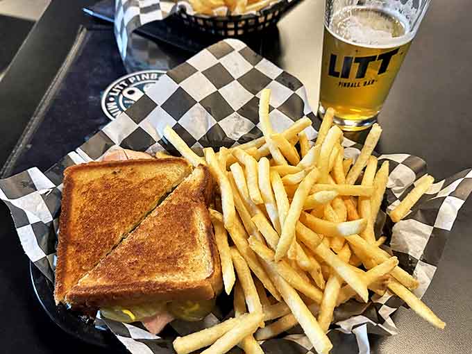 A perfectly pressed grilled sandwich sits beside golden fries &ndash; simple pleasures executed with surprising attention to detail.