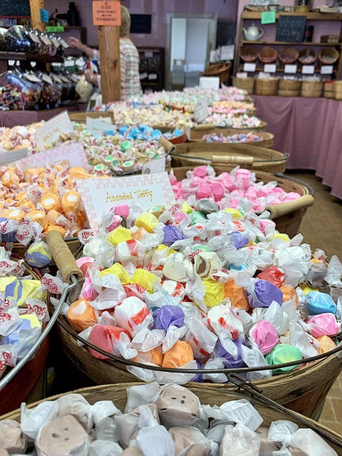 Saltwater taffy in every pastel shade imaginable fills metal tubs, each piece a tiny, chewy vacation for your mouth.
