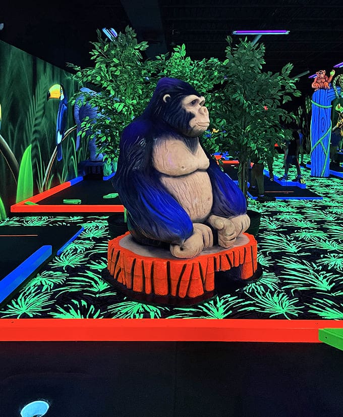 A contemplative gorilla watches over golfers, silently judging your putting technique while perched on his glowing red platform.