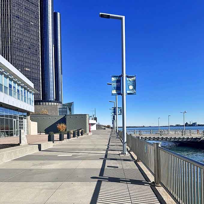 Shadows dance across the RiverWalk's immaculate pathways, where the Renaissance Center towers above like a glass-and-steel guardian of Detroit's renaissance.
