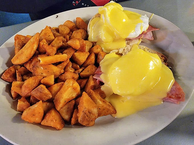 Eggs Benedict done right &ndash; English muffins supporting towers of ham and poached eggs, all blanketed in hollandaise that gleams like liquid sunshine.