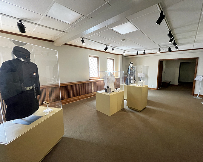This uniform display showcases the evolution of official attire, from an era when authority figures dressed like they meant serious business.