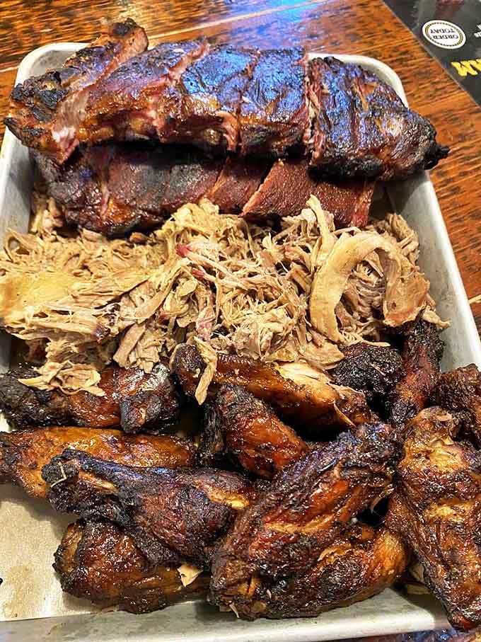 The Pitmaster's Feast &ndash; a carnivore's dream team of ribs, pulled pork, and chicken that's worth every napkin you'll need.
