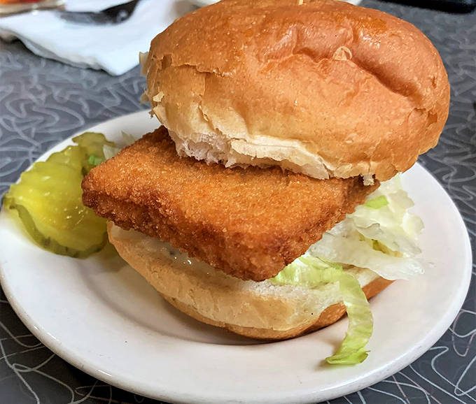 The fish sandwich extends well beyond its bun's boundaries &ndash; a delicious reminder that good things don't always come in neat packages.