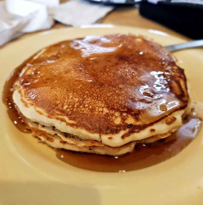 Golden pancakes glistening with syrup demonstrate that sometimes the classics need no improvement, just proper execution and generous portions.