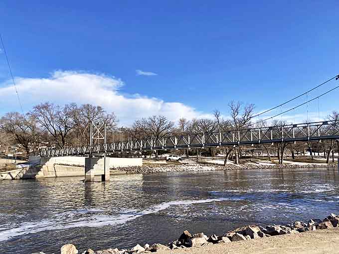 The historic Granite Falls Footbridge spans the rushing Minnesota River, connecting past and present with every crossing.