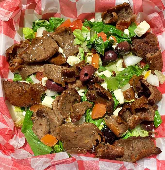 The Greek gyro salad proves that healthy-ish options can still be indulgent, with seasoned meat playing hide-and-seek among fresh vegetables.